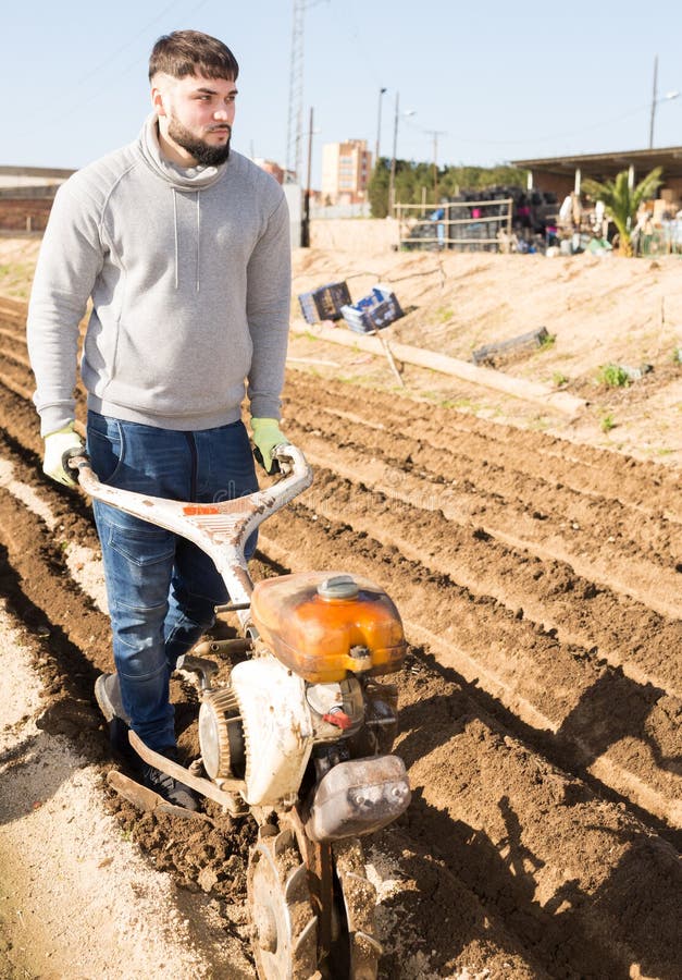 Young Farmer Using Small Mechanical Plow Stock Photo - Image of ...