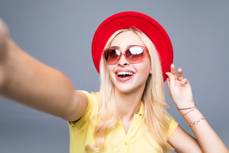 Young Beautiful Fashion Woman Take Selfie From Hands Phone On Gray