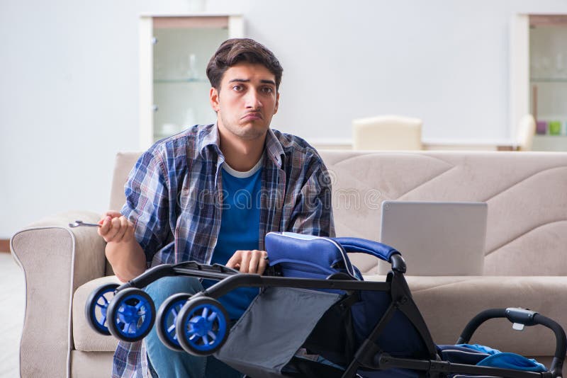 The Young Father Assembling Baby Pram at Home Stock Image - Image of ...