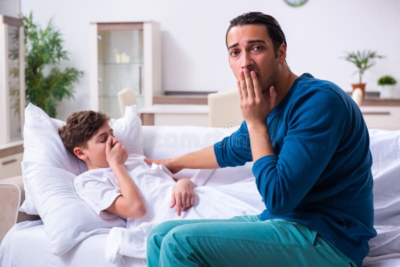Young Father Caring for Sick Son Stock Image - Image of couch, care ...