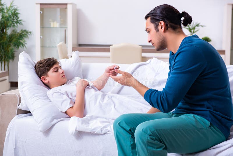 Young Father Caring for Sick Son Stock Image - Image of family, pain ...