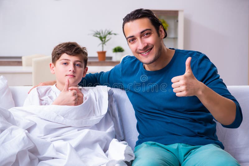 Young Father Caring for Sick Son Stock Photo - Image of medical, high ...