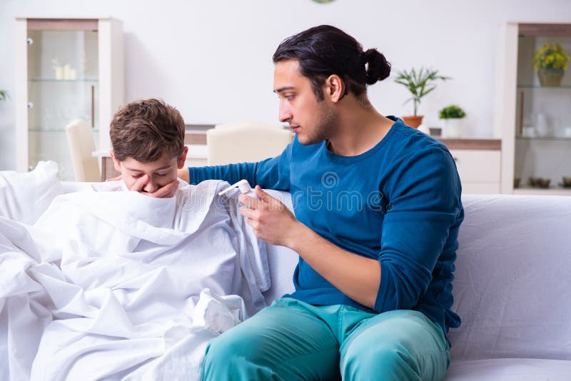 Young Father Caring for Sick Son Stock Image - Image of medical, caring ...