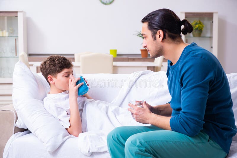 Young Father Caring for Sick Son Stock Image - Image of patient, parent ...