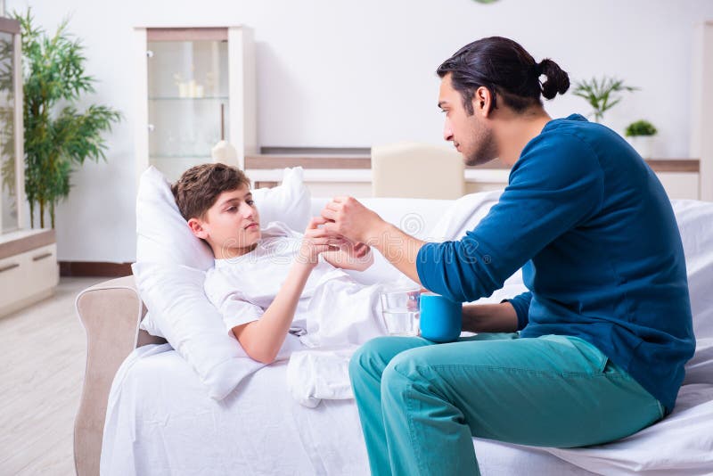 Young Father Caring for Sick Son Stock Photo - Image of pills, fever ...