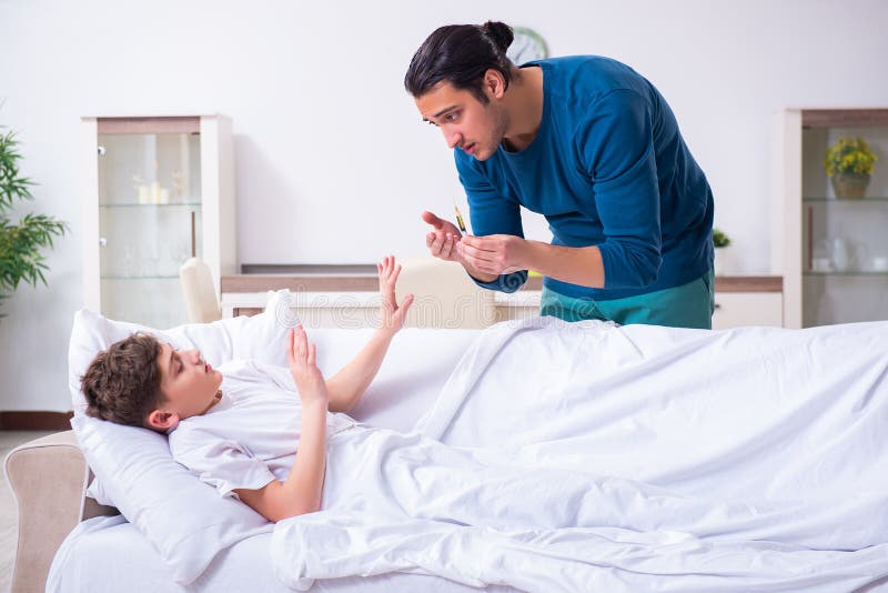 Young Father Caring for Sick Son Stock Photo - Image of illness, parent ...