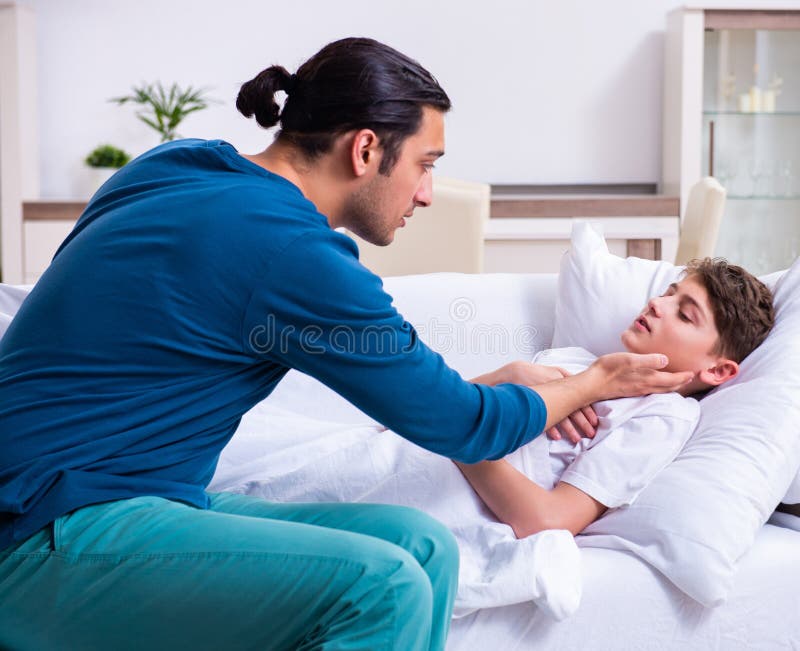 Young Father Caring for Sick Son Stock Photo - Image of sick, home ...