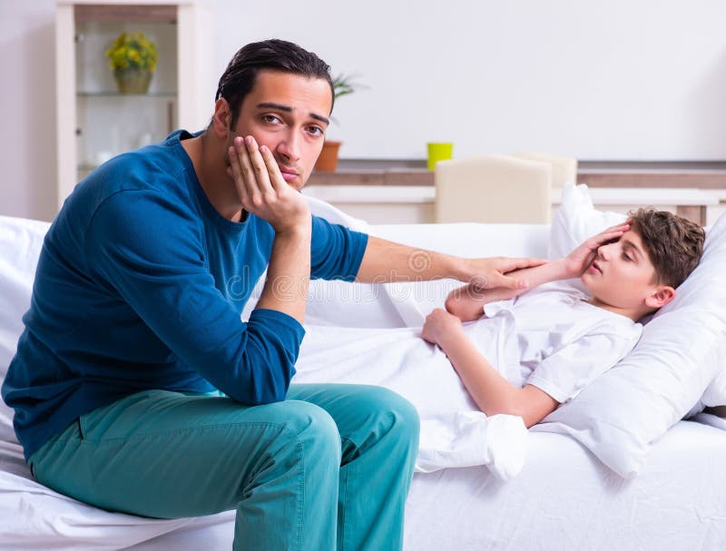 Young Father Caring for Sick Son Stock Image - Image of care, medical ...