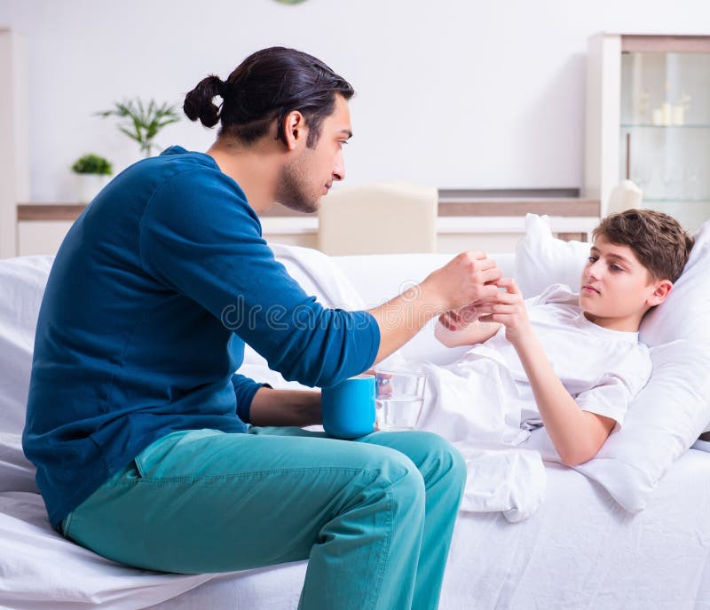 Young Father Caring for Sick Son Stock Image - Image of father, health ...