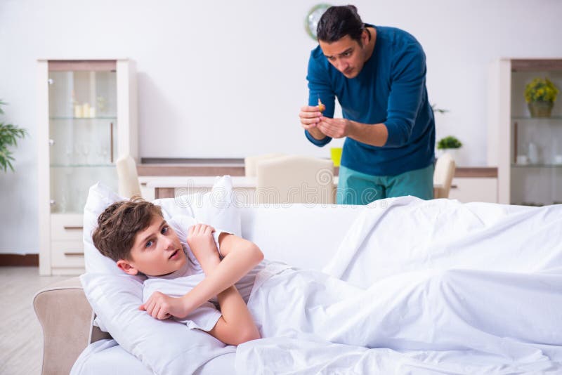 Young Father Caring for Sick Son Stock Photo - Image of healthcare ...
