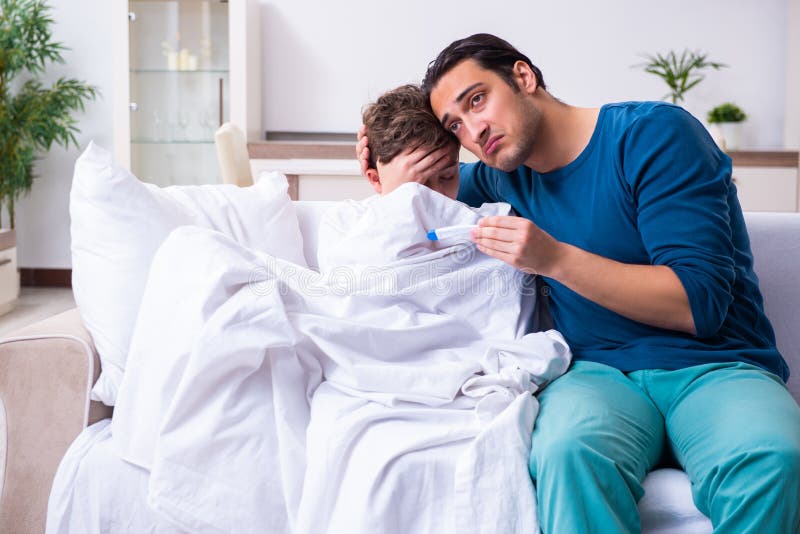 Young Father Caring for Sick Son Stock Photo - Image of home, leave ...
