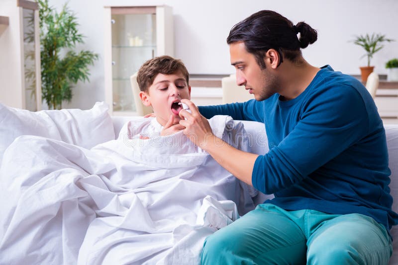 Young Father Caring for Sick Son Stock Photo - Image of medicine ...