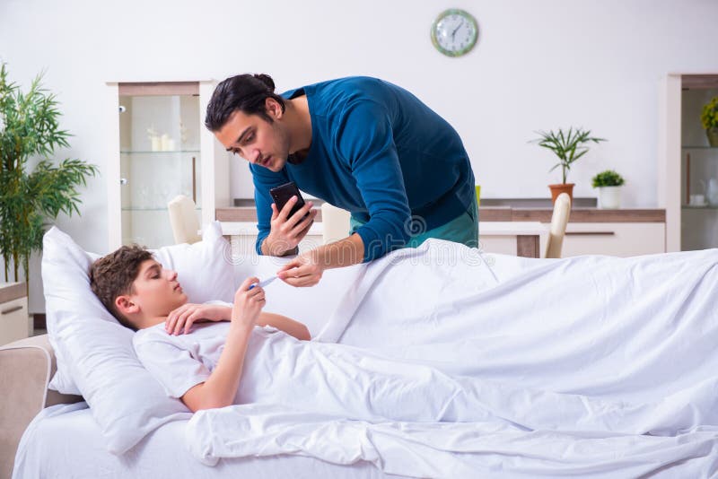 Young Father Caring for Sick Son Stock Photo - Image of illness, pain ...