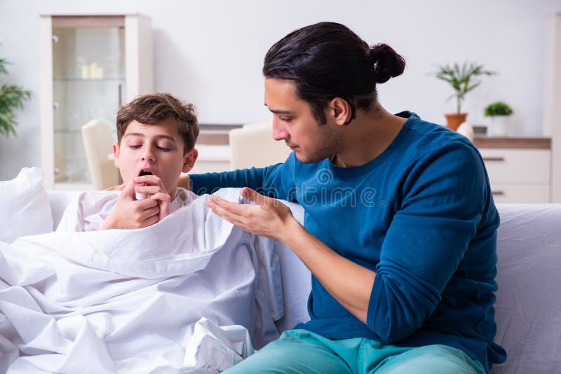 Young Father Caring for Sick Son Stock Photo - Image of leave, father ...