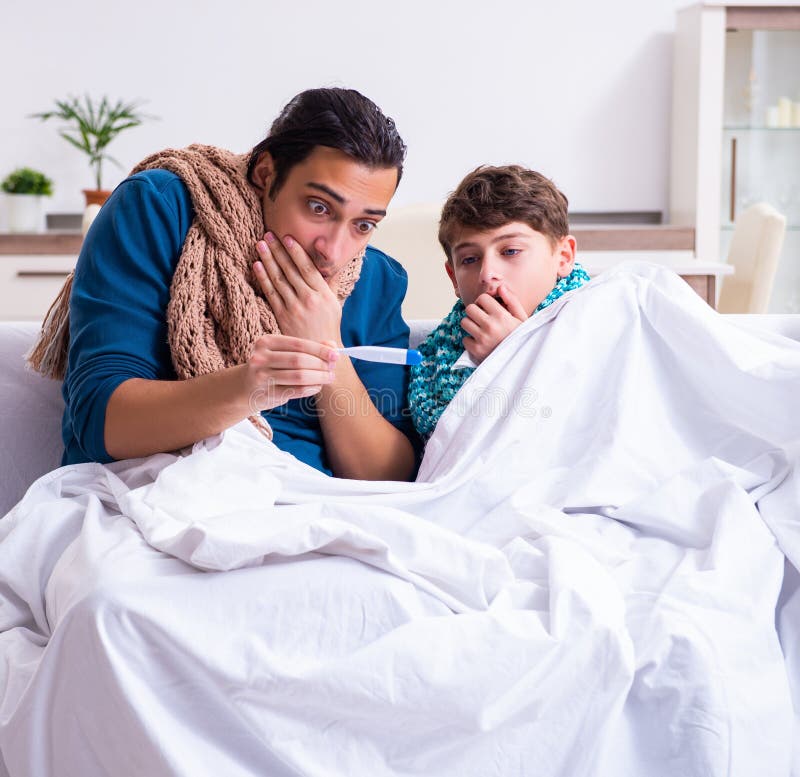 Young Father Caring for Sick Son Stock Image - Image of family ...