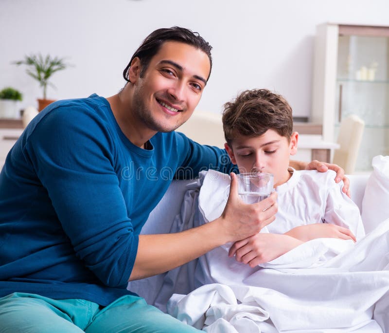 Young Father Caring for Sick Son Stock Photo - Image of disease, leave ...