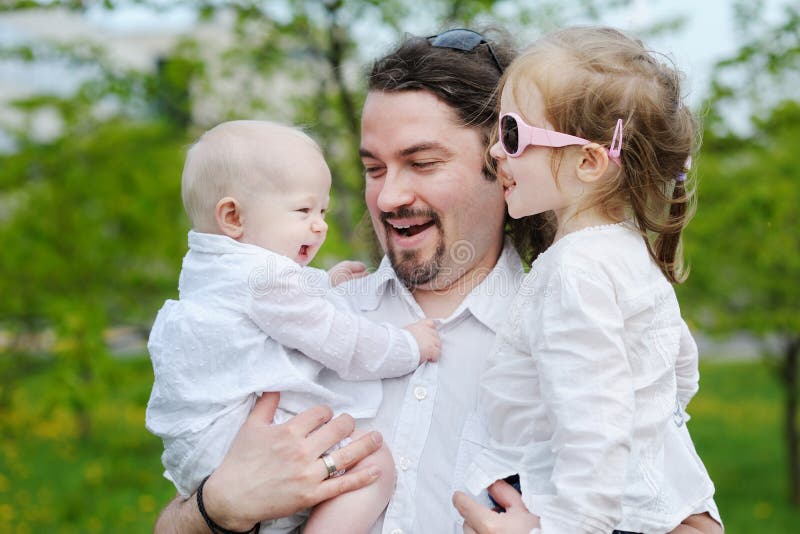 Young Father and His Two Daughters Stock Photo - Image of face, fields ...