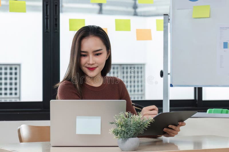 Young Female Accountant Analyzing Financial Documents in Modern Office ...