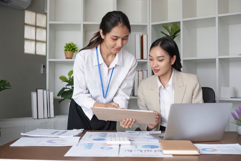 Young Female Accountants Collaborating on Financial Contract Document ...