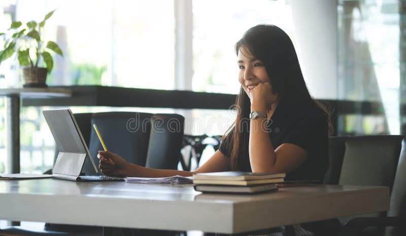 A Young Female Administrative Assistant Making Notes of Working ...