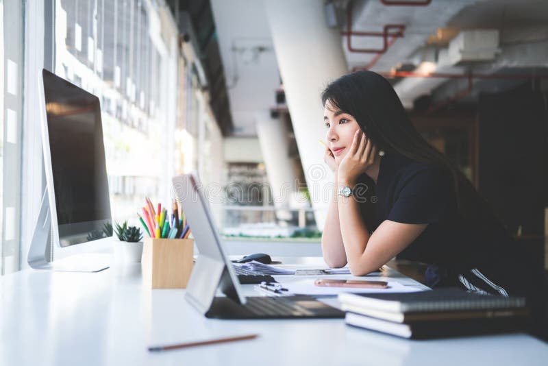 A Young Female Administrative Assistant Making Notes of Working ...