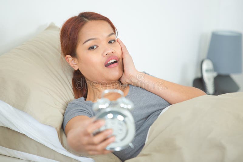 Young Female with Alarm Clock in Bed Stock Image - Image of alarm ...