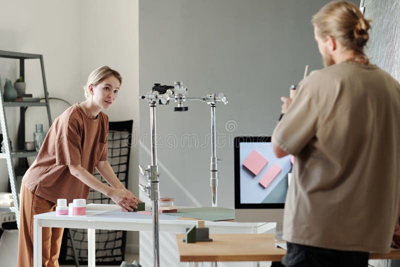 Young Female Assistant of Photographer Laying Out Objects on Table ...