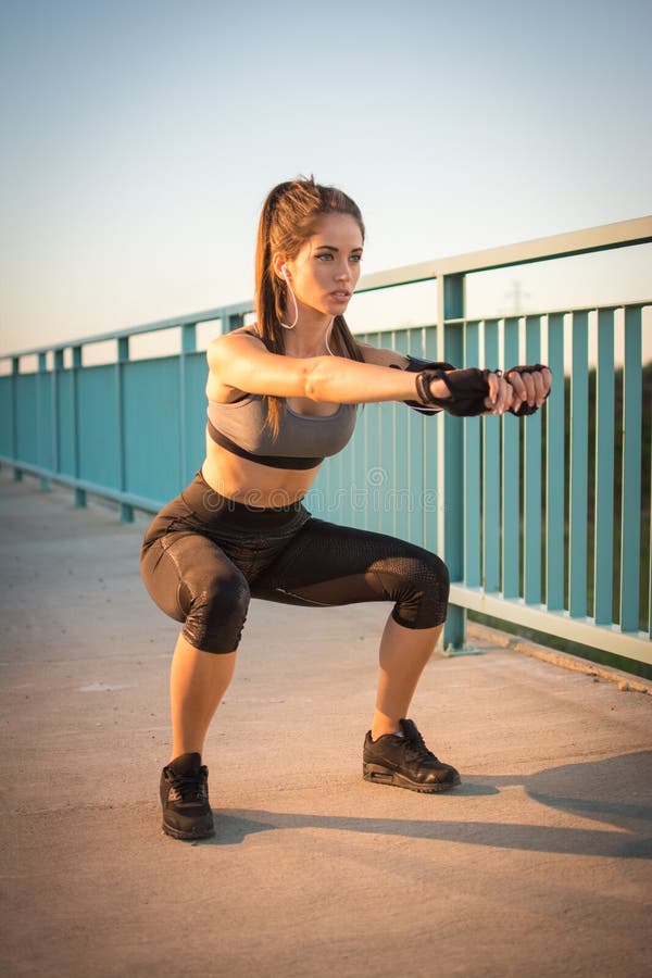 Young Female Athlete Doing Squat Exercises Outdoors. Stock Image ...