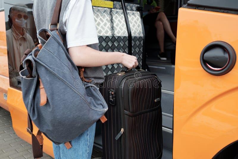 Young Female with Backpack and Suitcase Entering Bus Stock Image ...