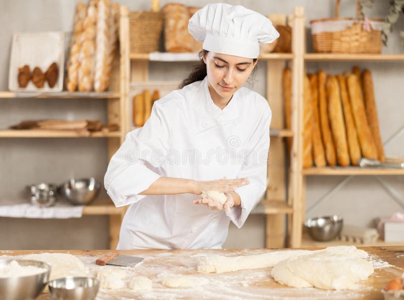 Young Female Baker Kneading Dough on Table Stock Photo - Image of baked ...