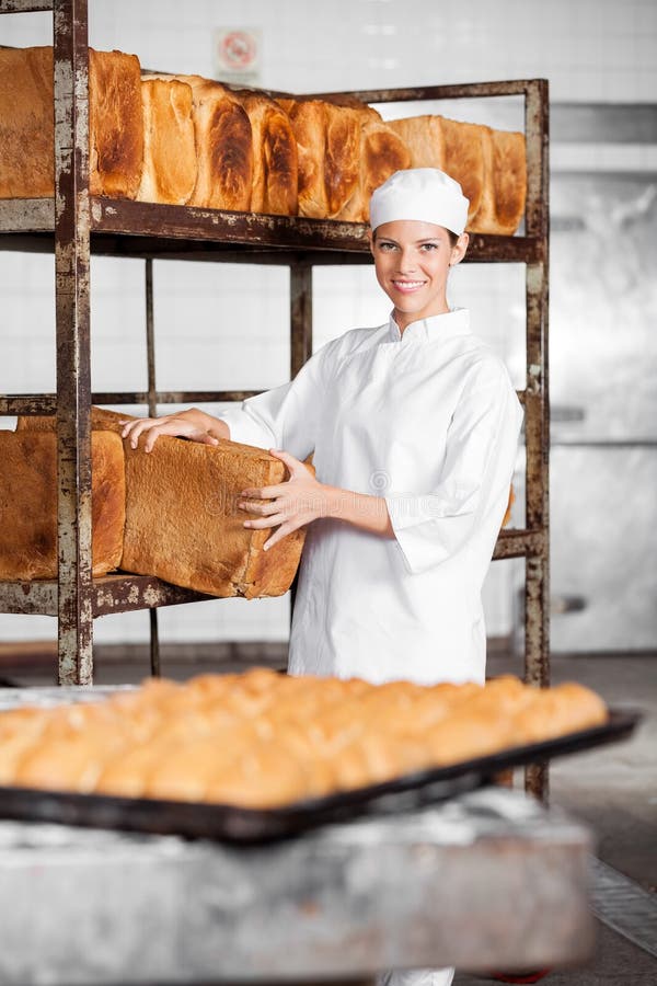 Female Baker Using Bread Slicer at Bakery Stock Photo - Image of female ...