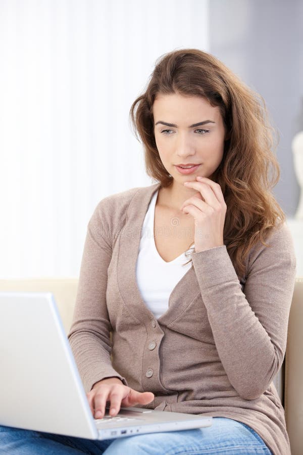 Young Female Browsing Internet at Home Stock Photo - Image of brunette ...