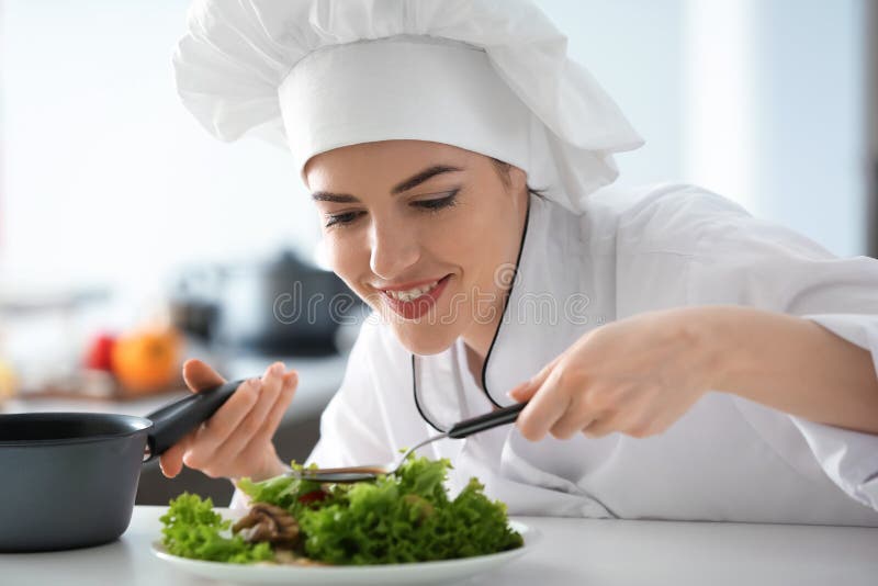 Young Female Chef Dressing Tasty Salad in Kitchen Stock Image - Image ...