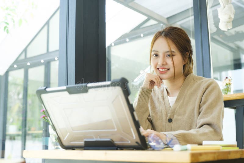 Young Female College Student Uses a Computer To Access the Internet for ...