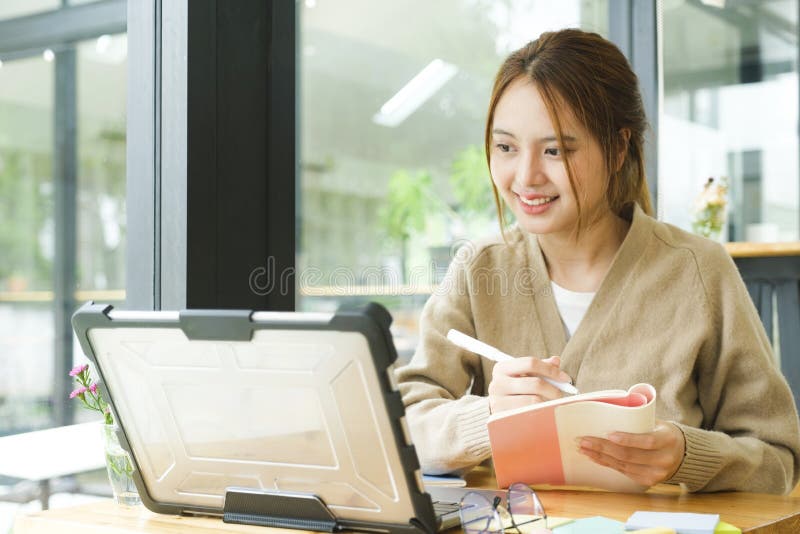 Young Female College Student Uses a Computer To Access the Internet for ...