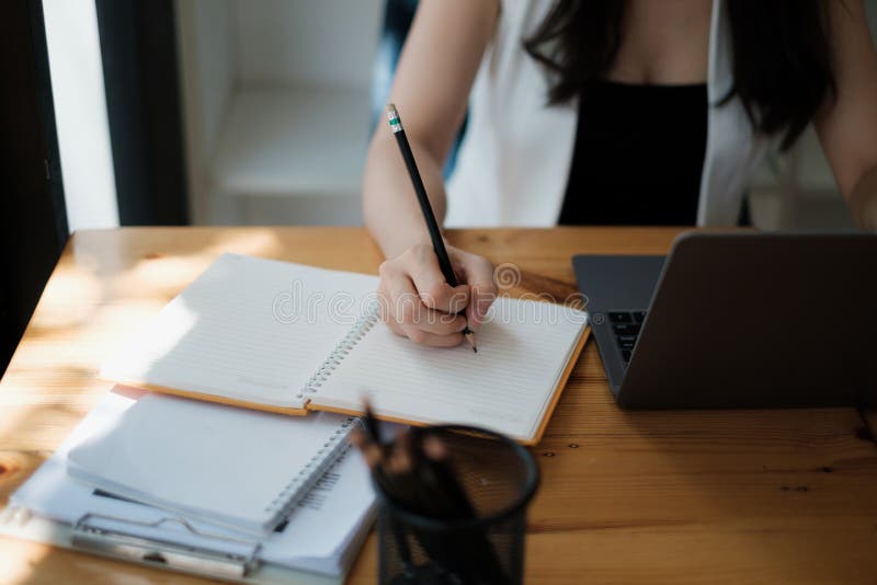 Young Female College Taking Notes and Using Highlighter. Focused ...