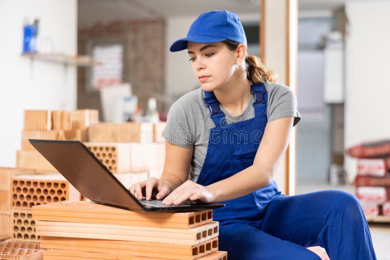 Young Female Contractor Using Laptop at Construction Site Indoors Stock ...