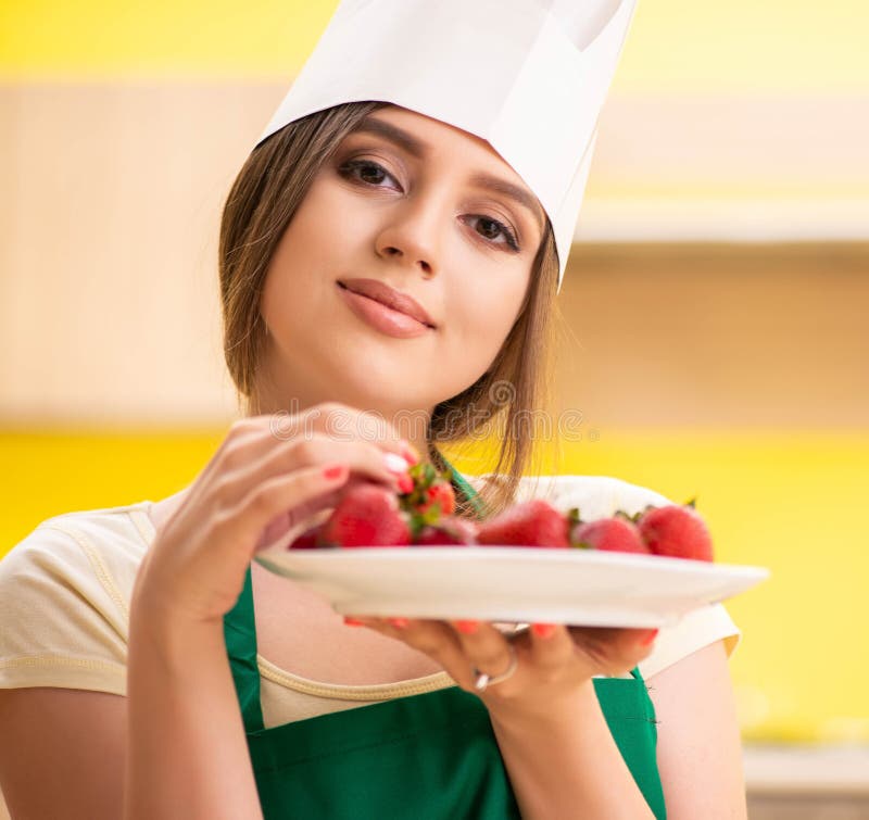 Young Female Cook Eating Strawberries Stock Image - Image of enjoying ...