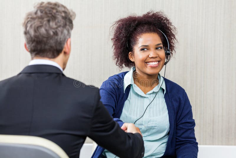 Young Female Customer Service Agent Shaking Hands Stock Image - Image ...