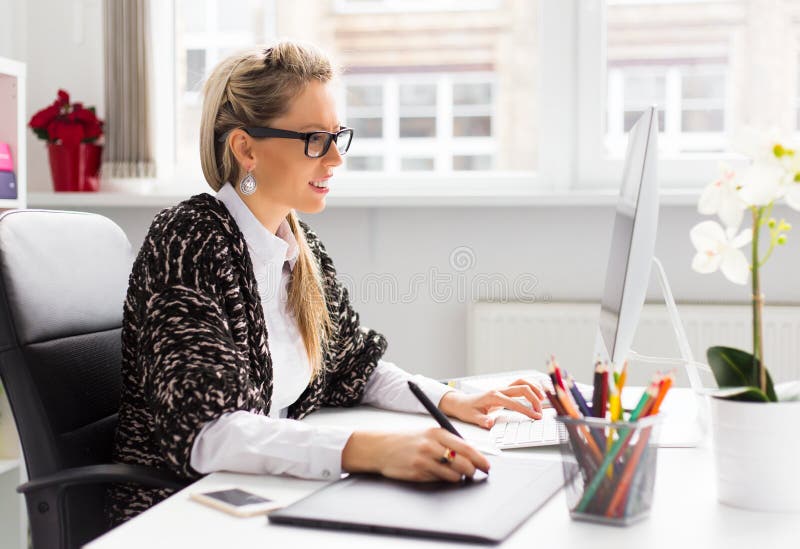 Young Female Designer Using Graphics Tablet while Working with Computer ...
