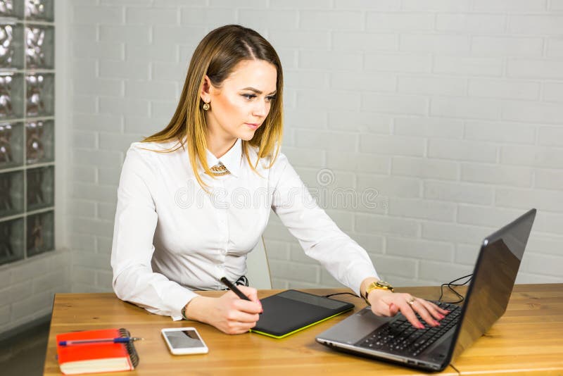 Young Female Designer Using Graphics Tablet while Working with Computer ...
