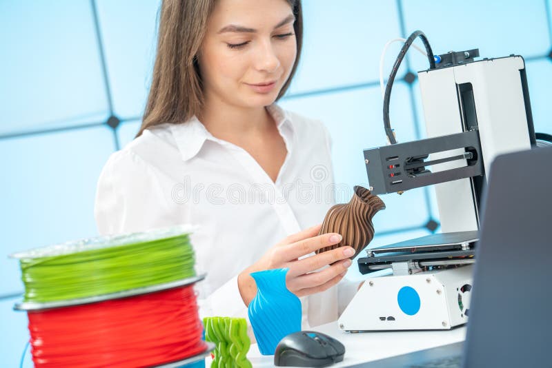 Young Female Designer Works with a 3D Printer in a Design Studio Stock ...
