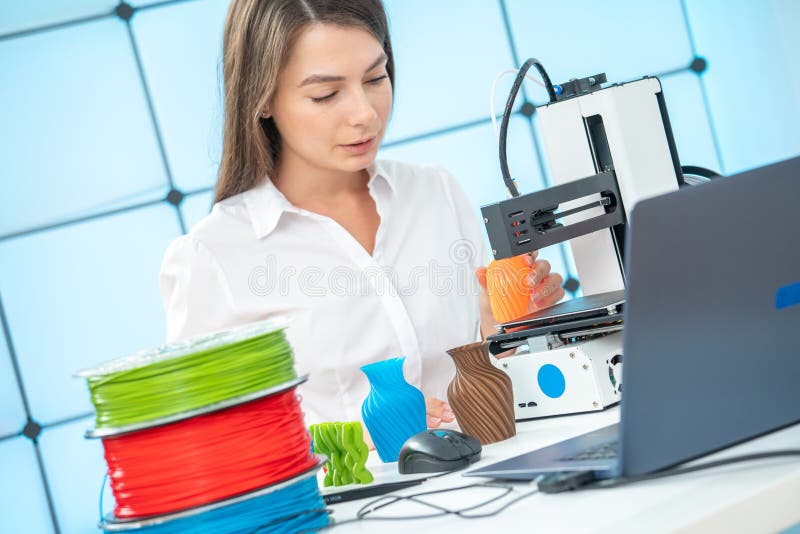 Young Female Designer Works with a 3D Printer in a Design Studio Stock ...