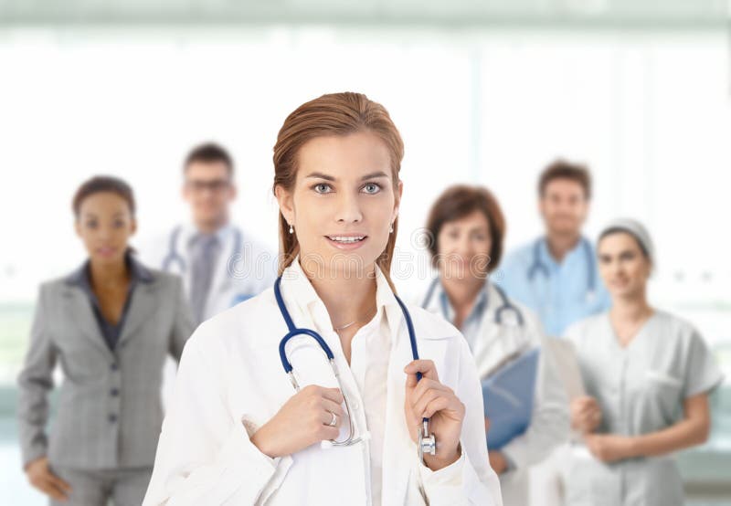 Young Female Doctor in Front of Medical Team Stock Image - Image of ...