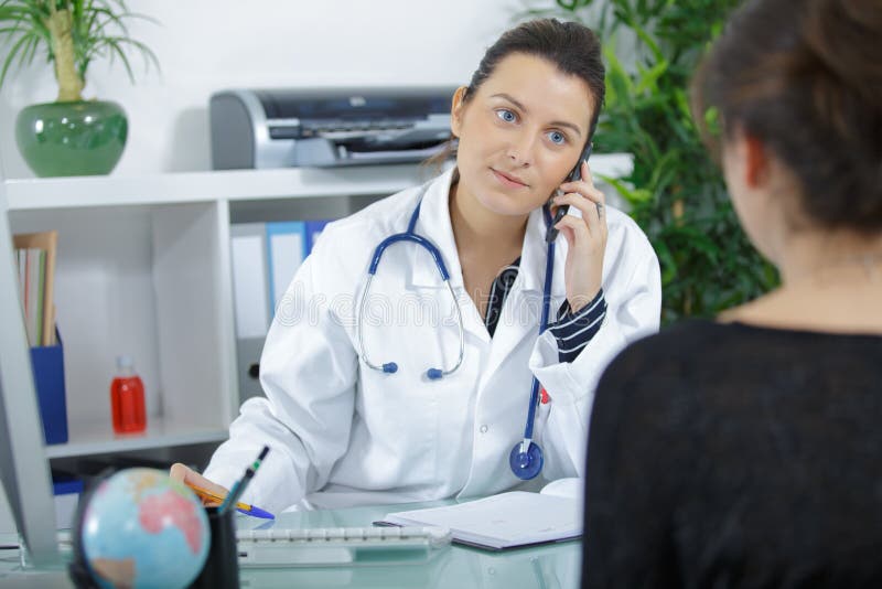 Young Female Doctor on Phone at Office Stock Photo - Image of call ...