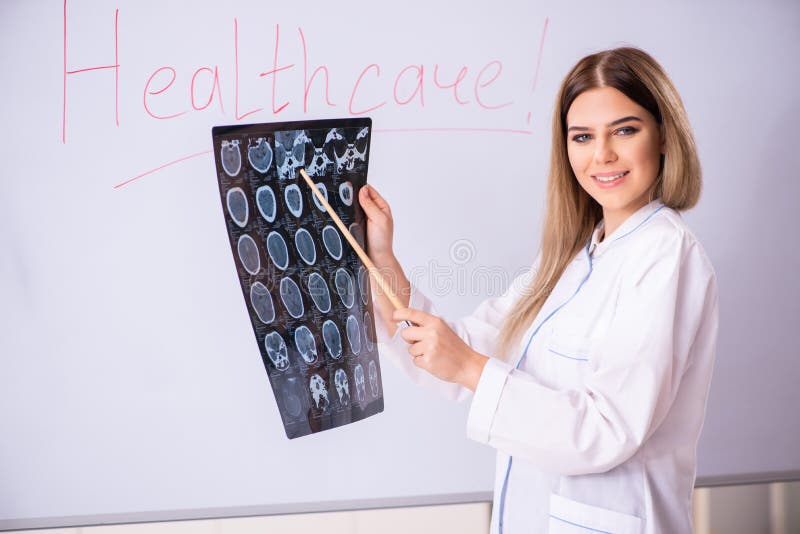 The Young Female Doctor Standing in Front of the White Board Stock ...