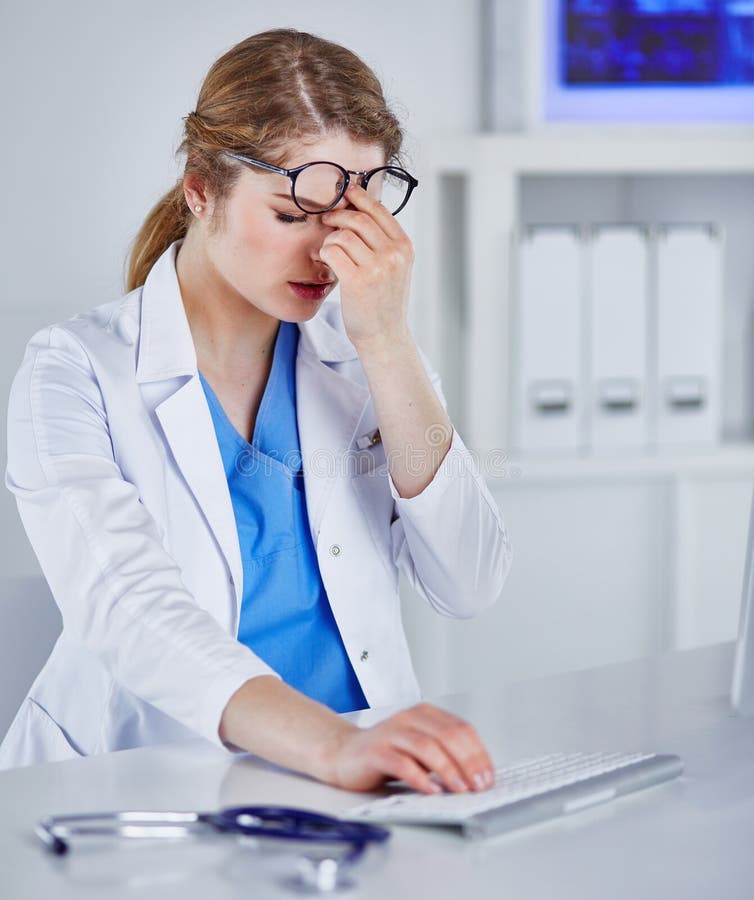 Young Female Doctor Tired after Working with Computer Stock Photo ...
