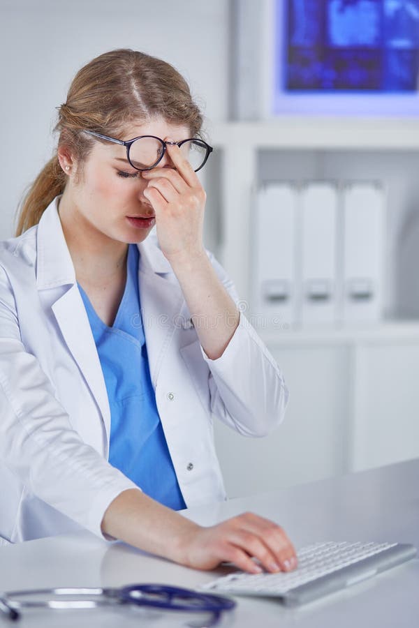 Young Female Doctor Tired after Working with Computer Stock Photo ...