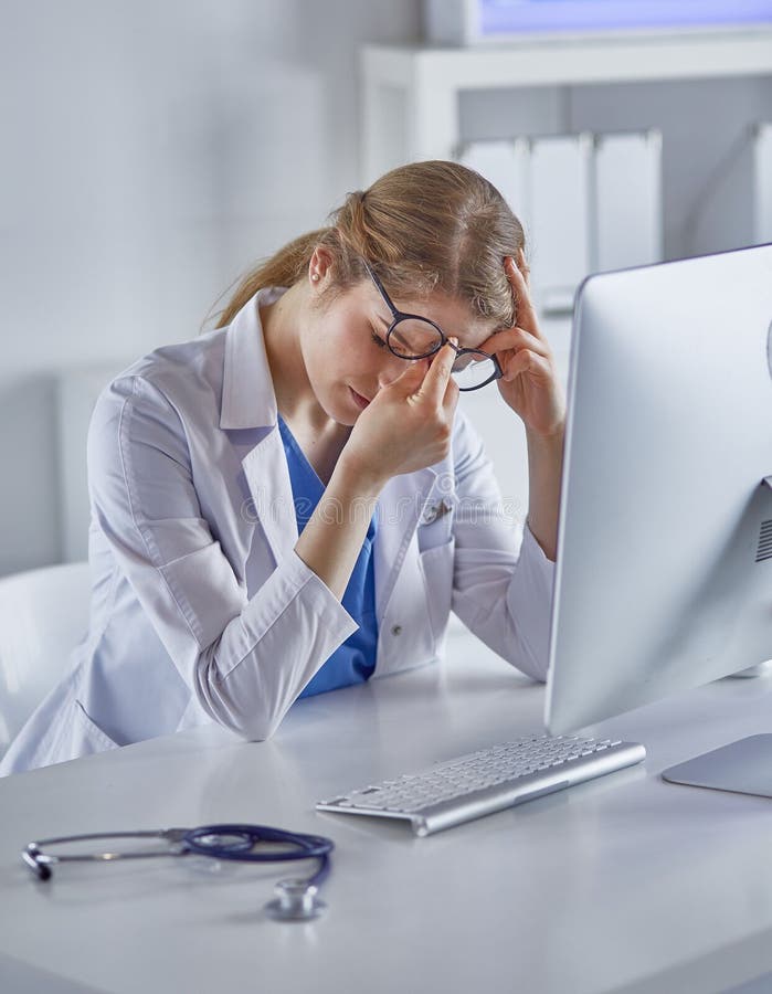 Young Female Doctor Tired after Working with Computer Stock Photo ...