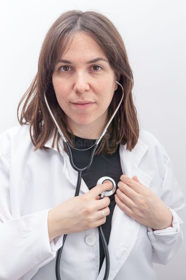 Young Female Doctor In A White Coat Posing Using A Stethoscope On